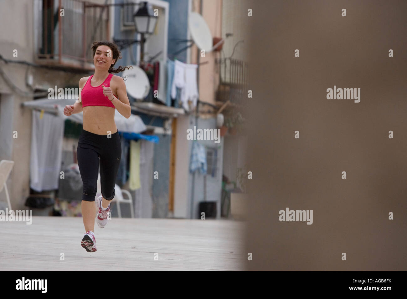 Female running in town Stock Photo - Alamy