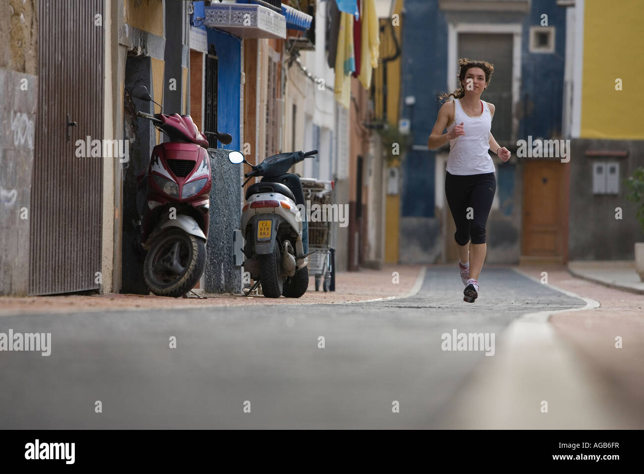 Female running in town Stock Photo - Alamy