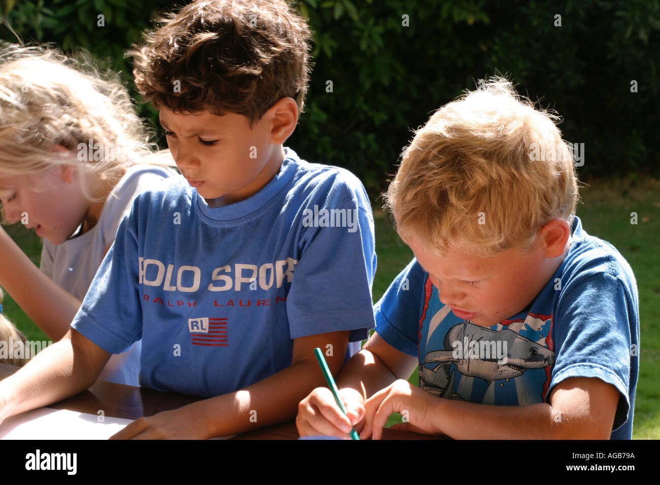 young school boys writing Stock Photo - Alamy