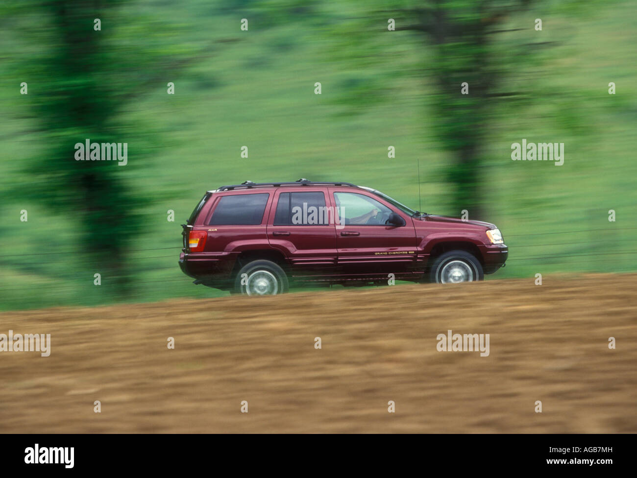 Jeep driving along a road Stock Photo - Alamy