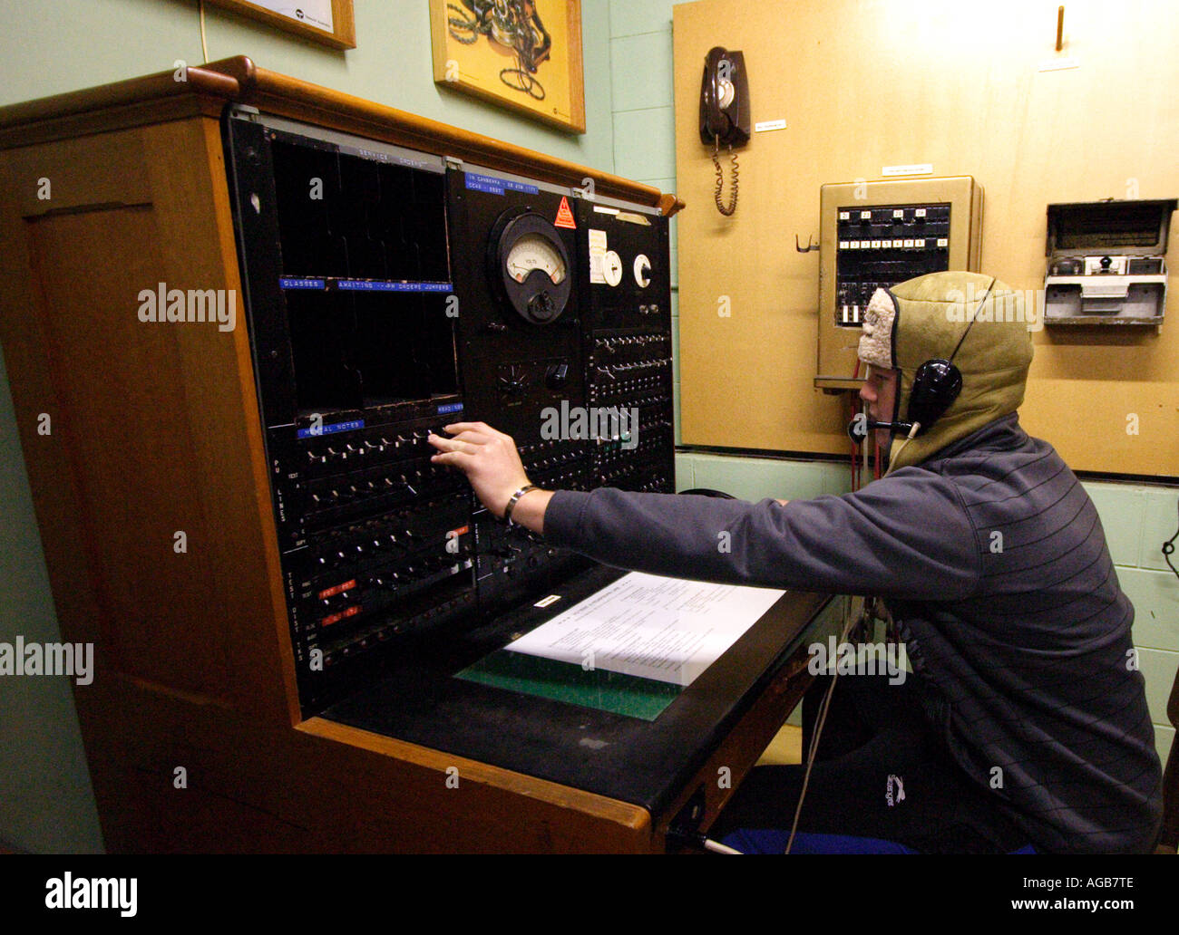 YOUNG MAN OPERATING OLD TELEPHONE SWITCHBOARD NOT LOOKING HORIZONTAL ...