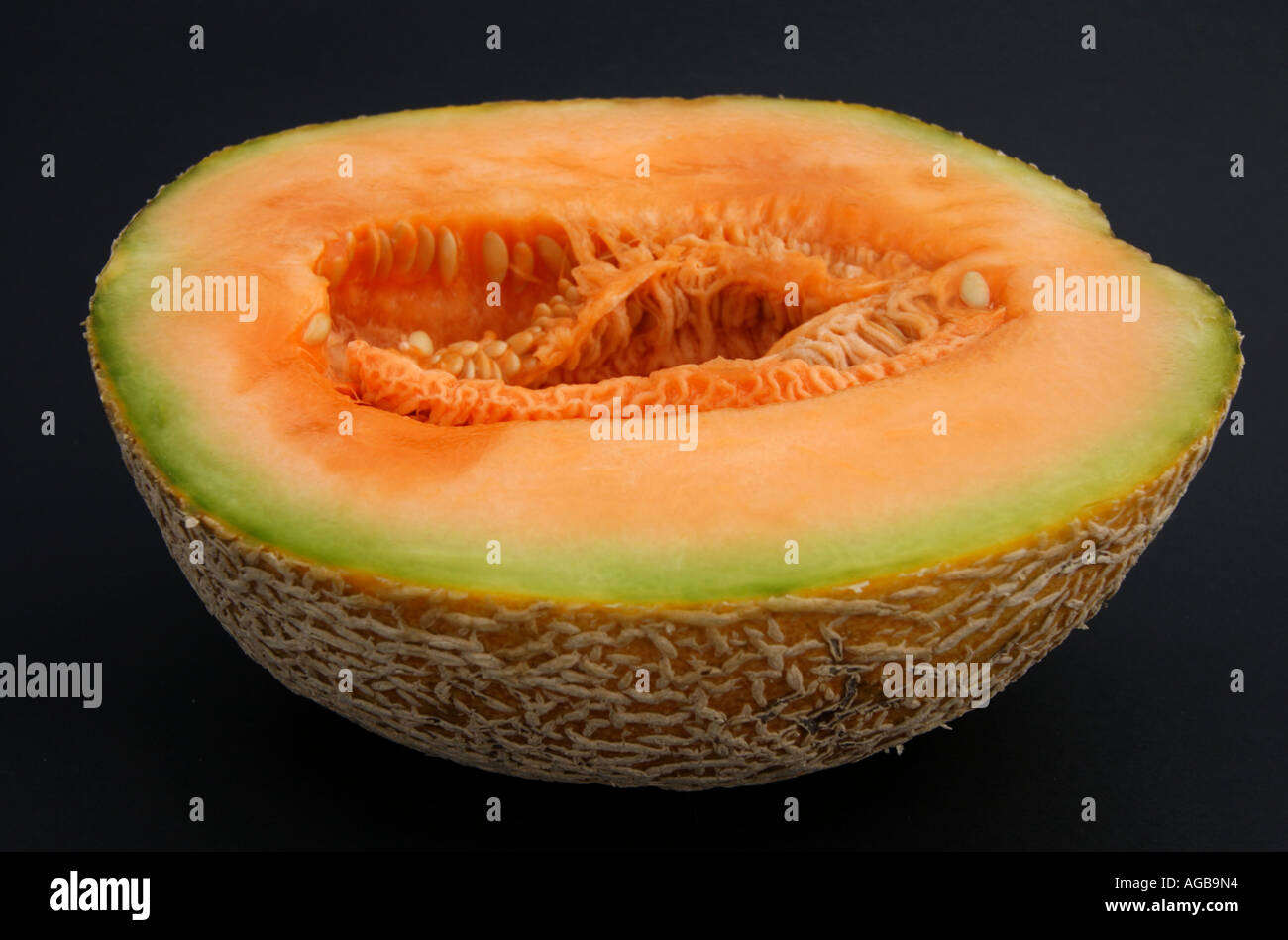 HALF A ROCKMELON BLACK BACKGROUND HORIZONTAL BAPDB8290 Stock Photo - Alamy