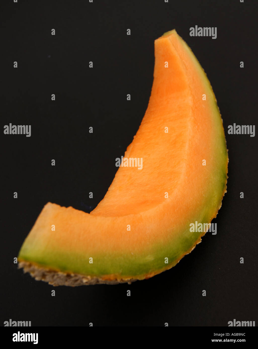 THIN SLICE OF ROCKMELON BLACK BACKGROUND VERTICAL BAPDB8295 Stock Photo ...