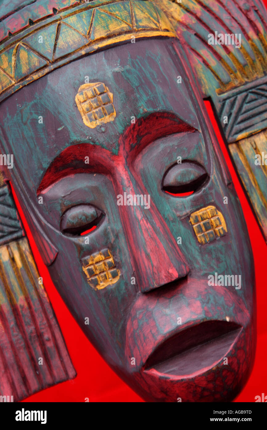 CARVED WOODEN TRIBAL MASK RED BACKGROUND VERTICAL BAPDB8156 Stock Photo ...