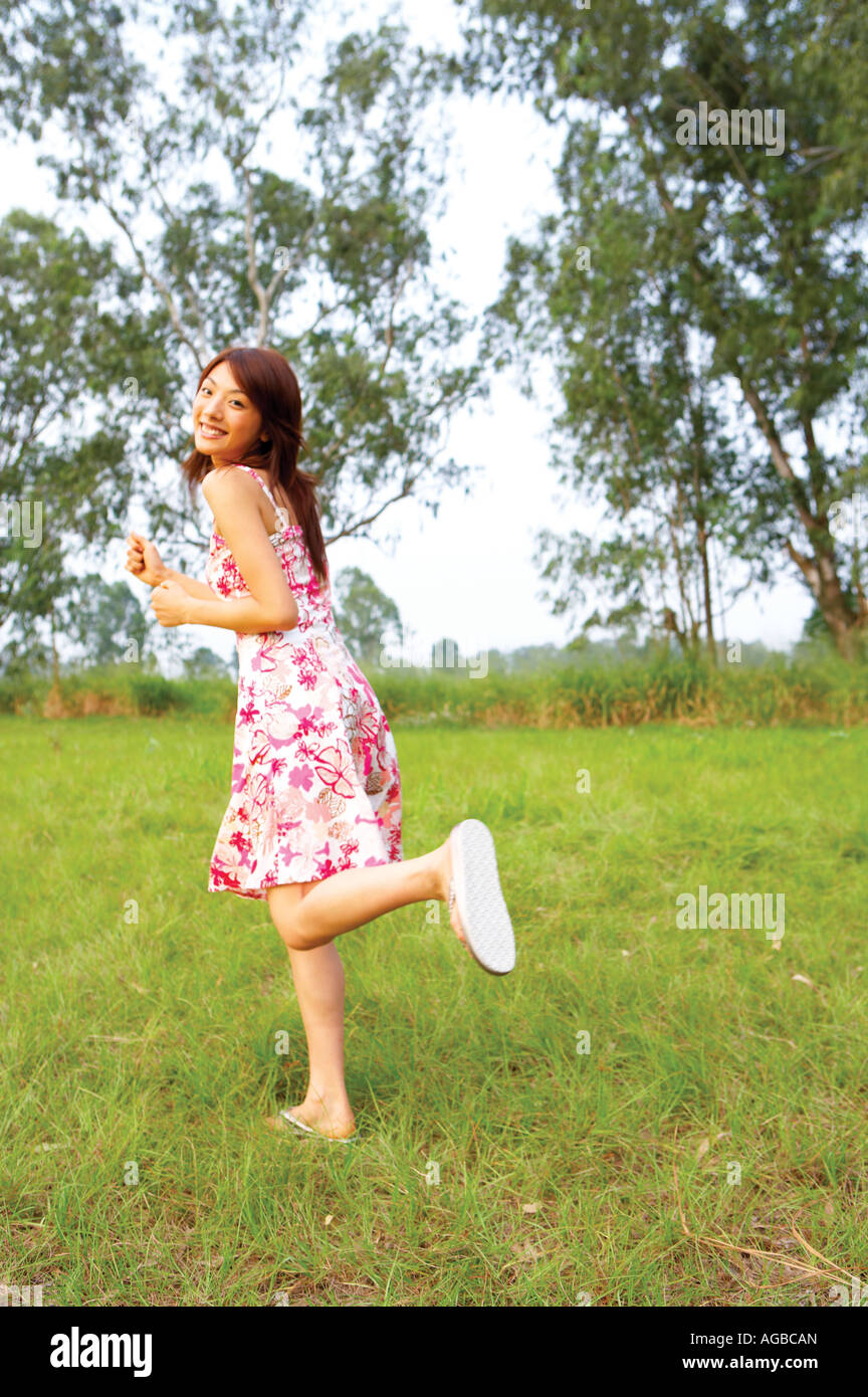 Young woman running on grasslands, laughing Stock Photo - Alamy