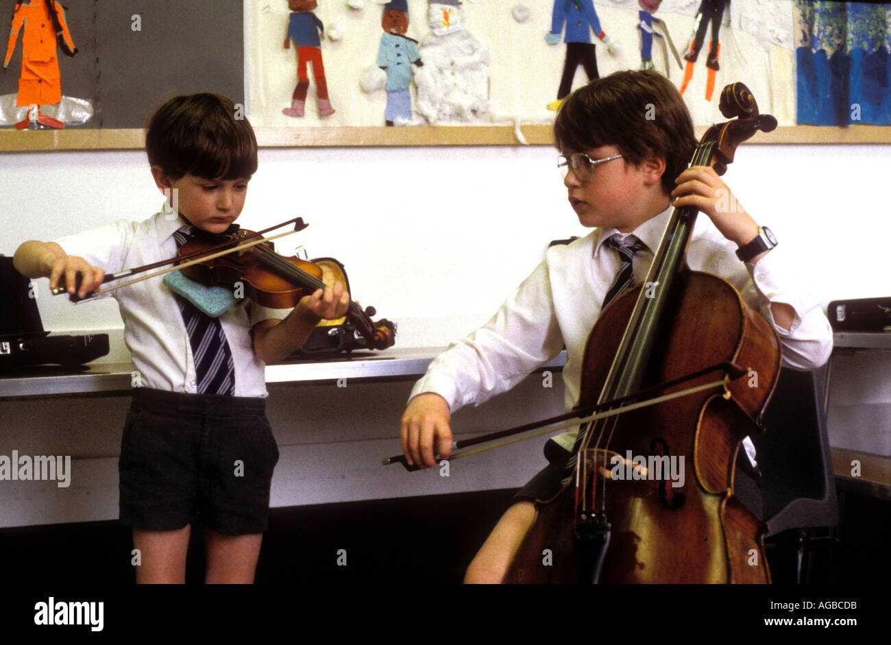 Two younGBoys playing musical instruments Stock Photo - Alamy