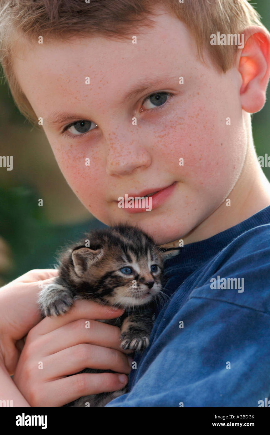 A Boy Holding A Kitten Stock Photo - Alamy