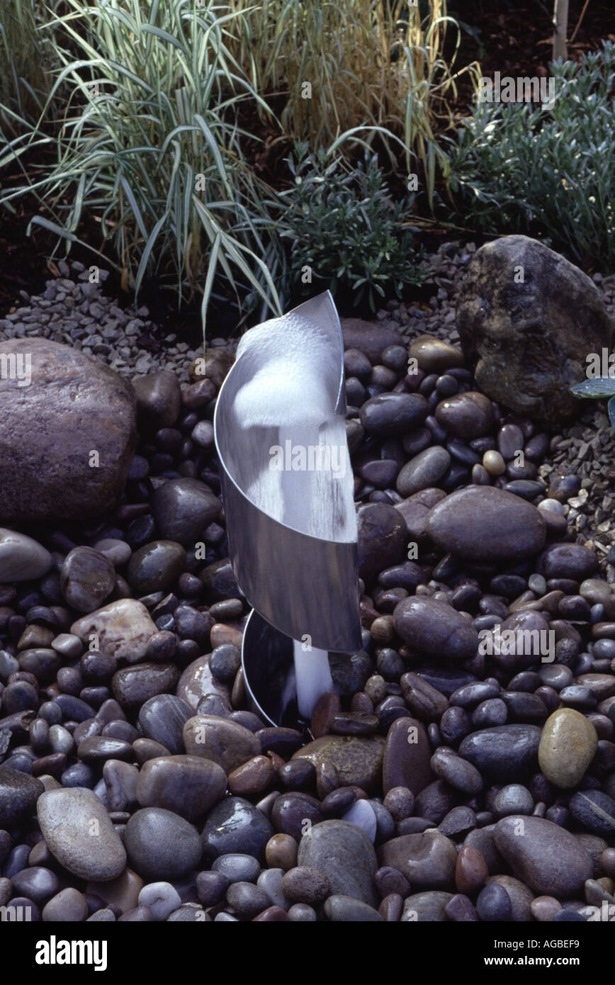 mall pebble Water Feature with metal spiral Stock Photo - Alamy