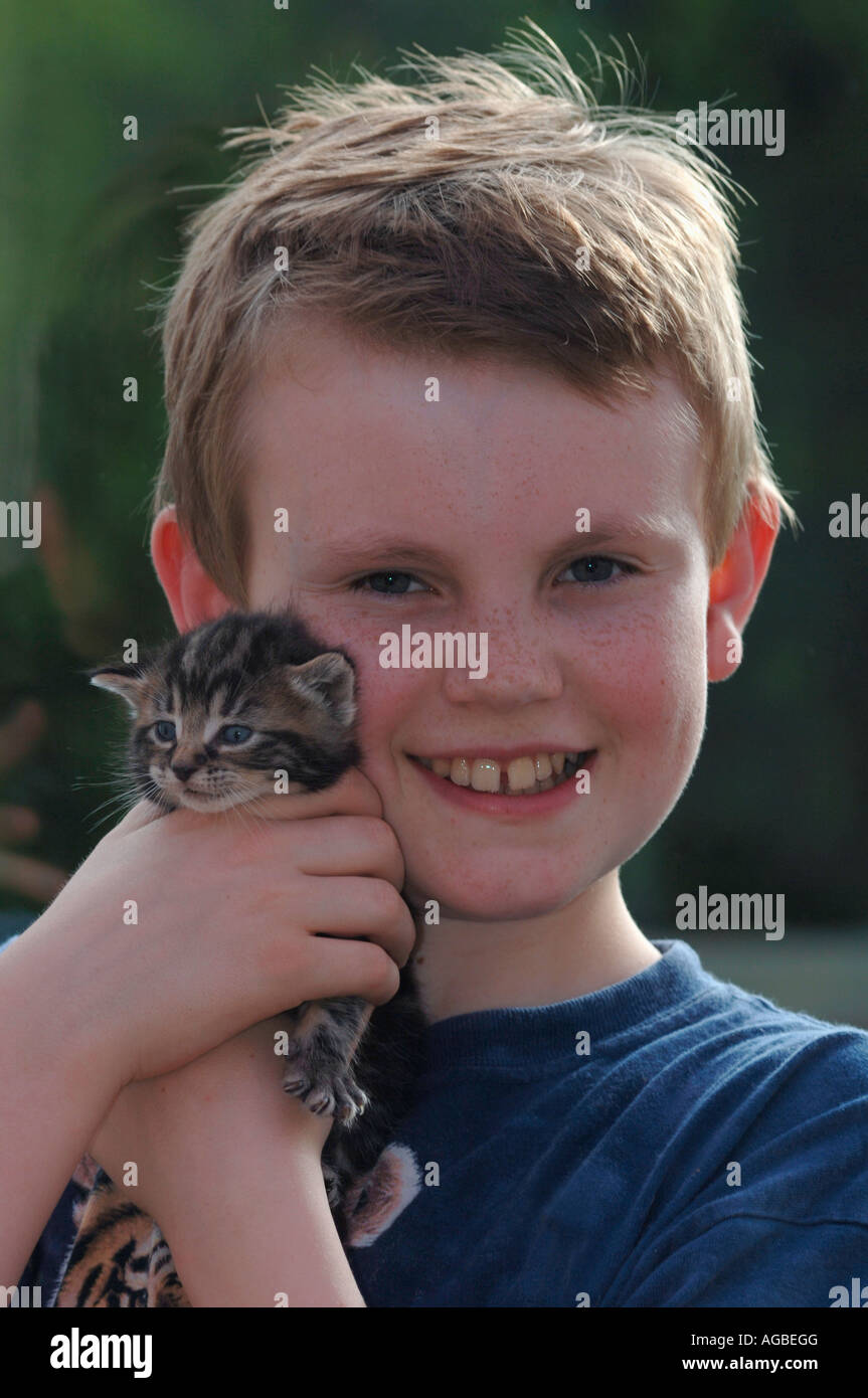 A Boy Holding A Kitten Stock Photo - Alamy