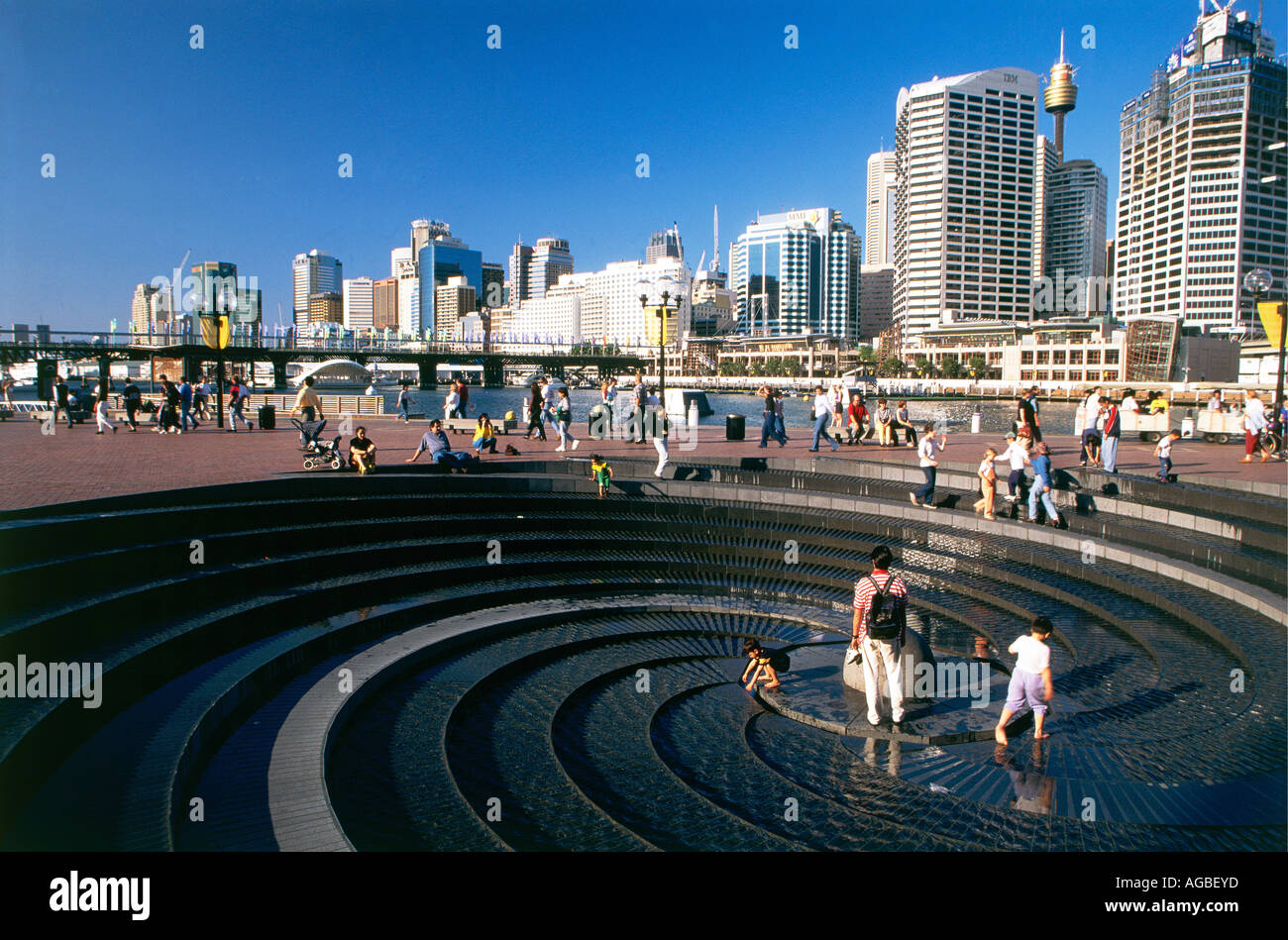 A family play in the swirling water feature known as the Tidal Cascade ...