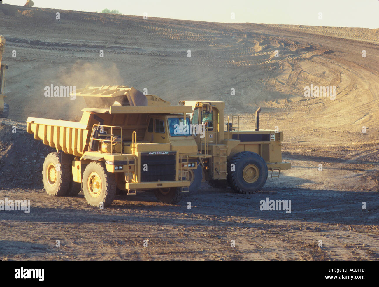 Caterpillar off road truck and Cat wheel loader at quarry or ...