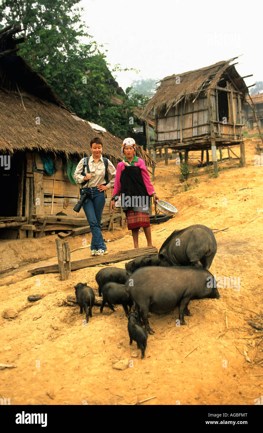 Laos, Luang Namtha, Tourist and woman of Hakha or Akha hill tribe ...