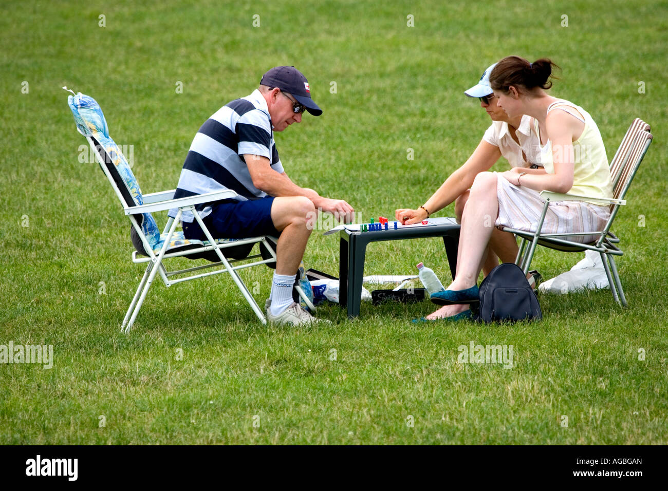 Two 2 people sat on chairs in green field playing a board game Stock ...