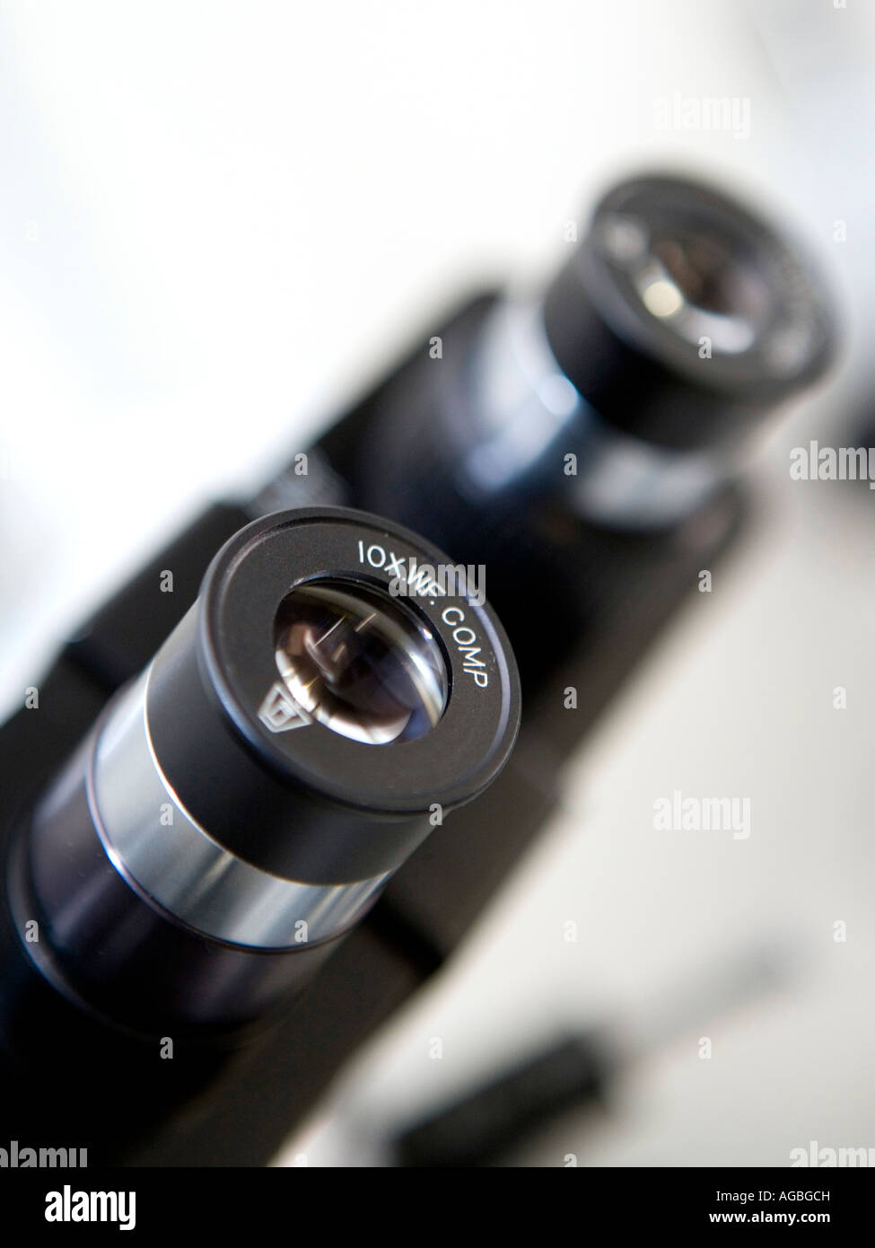 Microbiologist scientist looking through microscope and concentrating ...