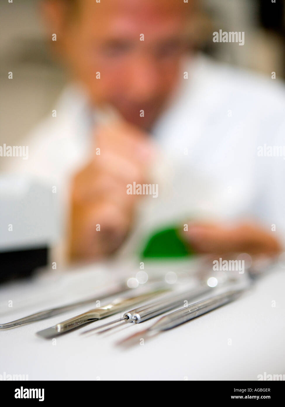 Microbiologist scientist looking through microscope and concentrating ...
