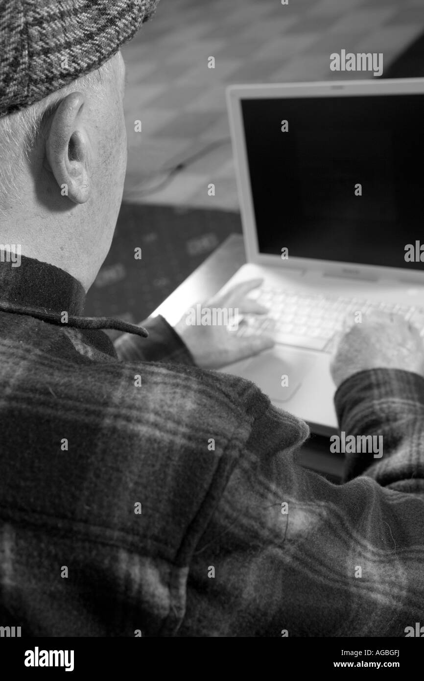 Old man in pub using Apple Mac laptop Stock Photo - Alamy