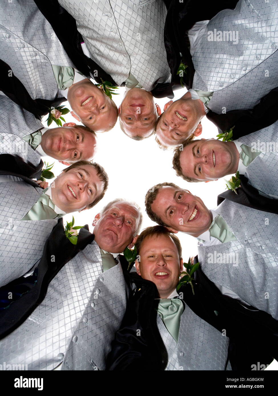 Group of men in wedding in a group hug like a scrum Stock Photo - Alamy