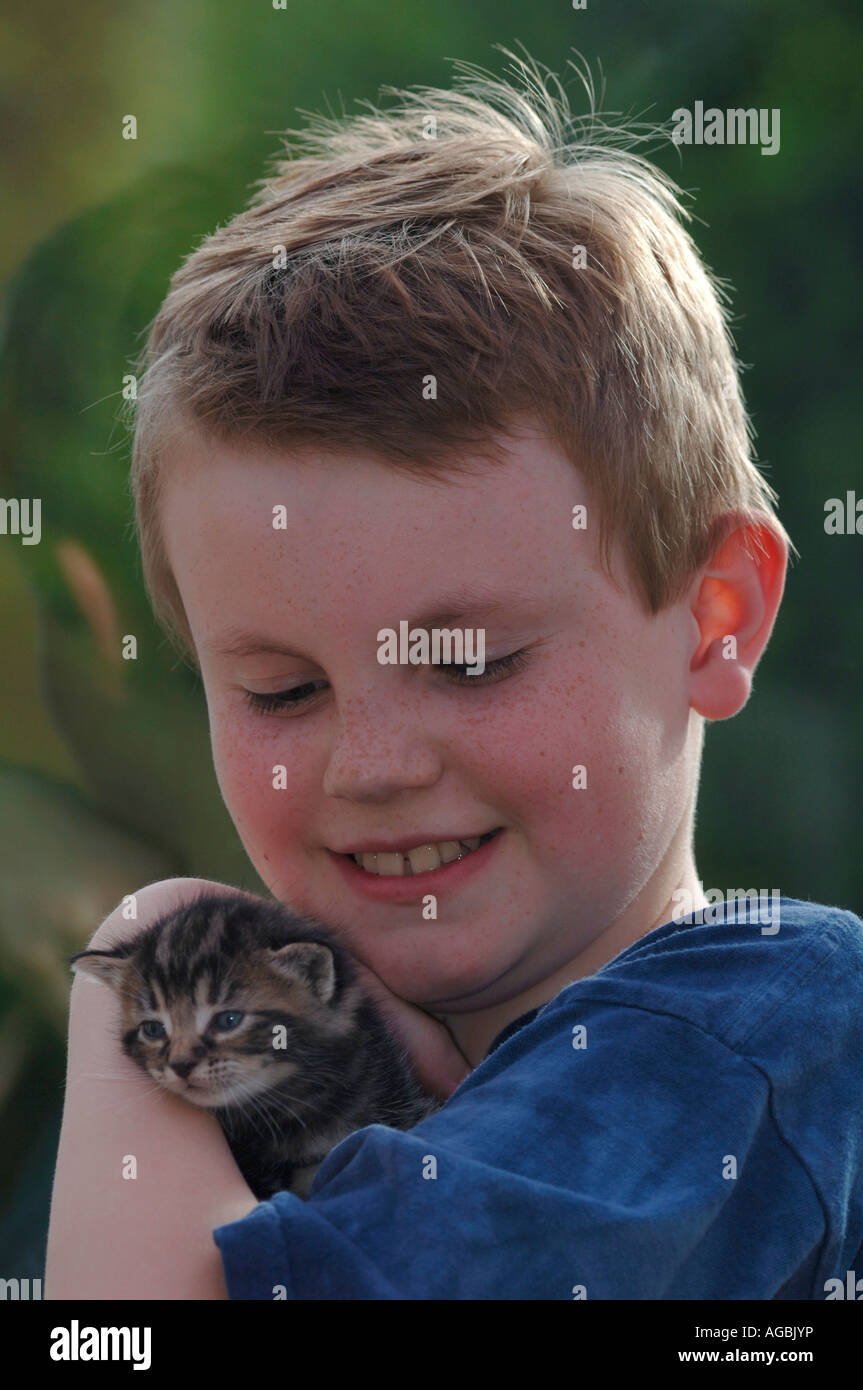 A Boy Holding A Kitten Stock Photo - Alamy
