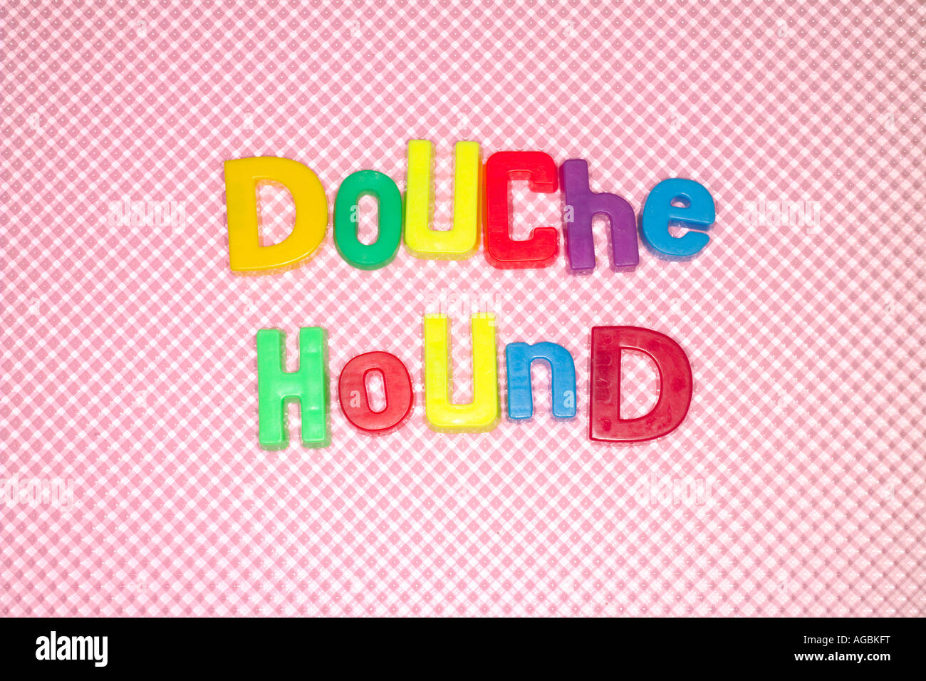 douche hound on pink background with fridge magnets Stock Photo - Alamy