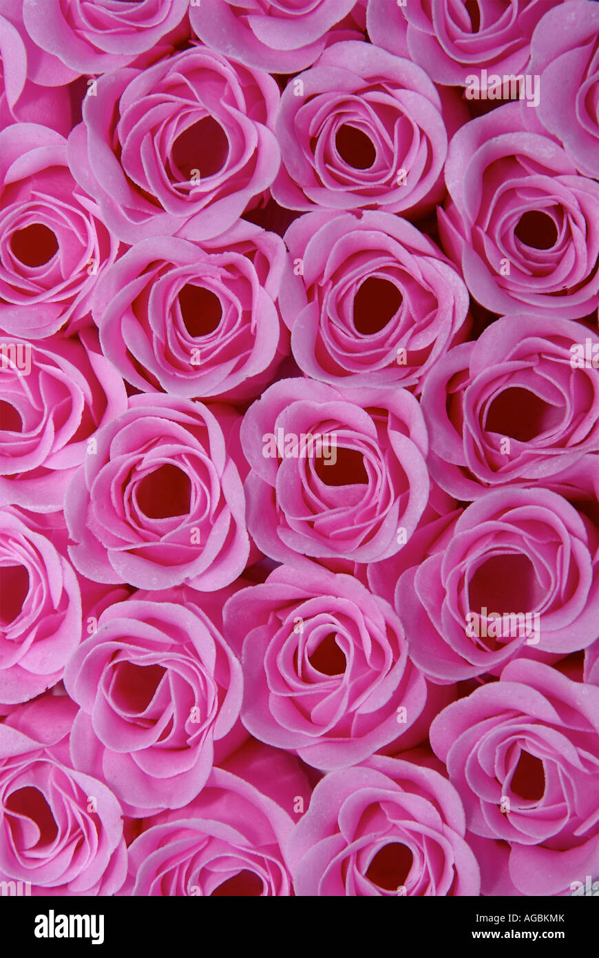 Lush pink roses are tightly packed together, creating a stunning floral ...