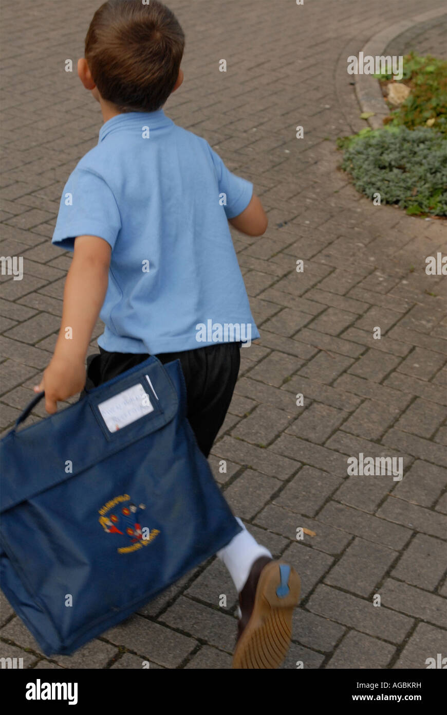 Rear view of a young boy wearing school uniform walking to school Stock ...