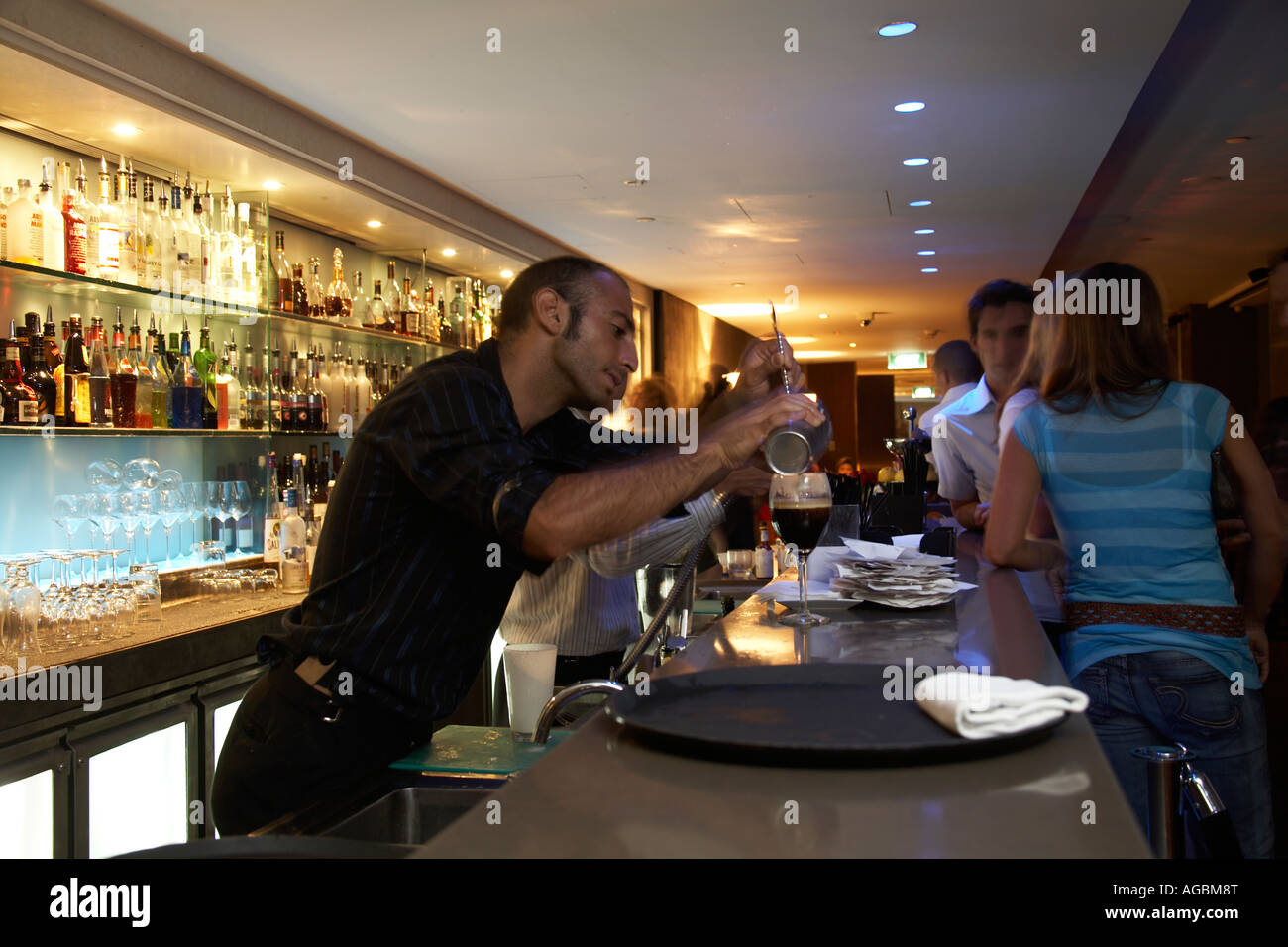Barman in bar of Shangri La hotel at night in Sydney New South Wales ...