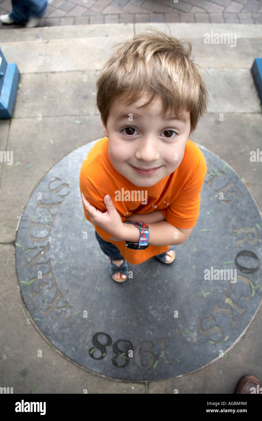 Young boy child from above smiling on first fleet memorial in Sydney ...
