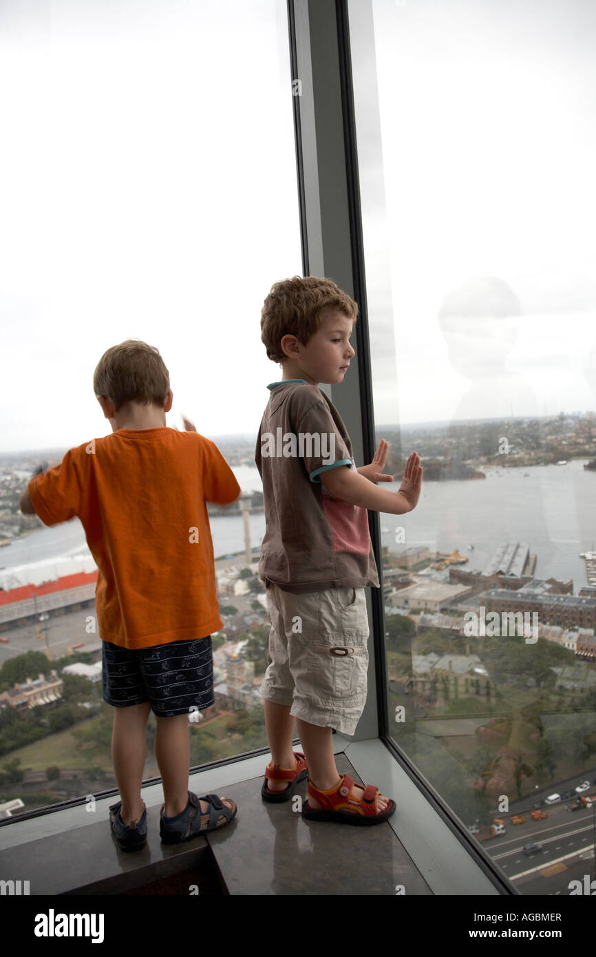 Two young boys children brothers looking at high level view from top of ...