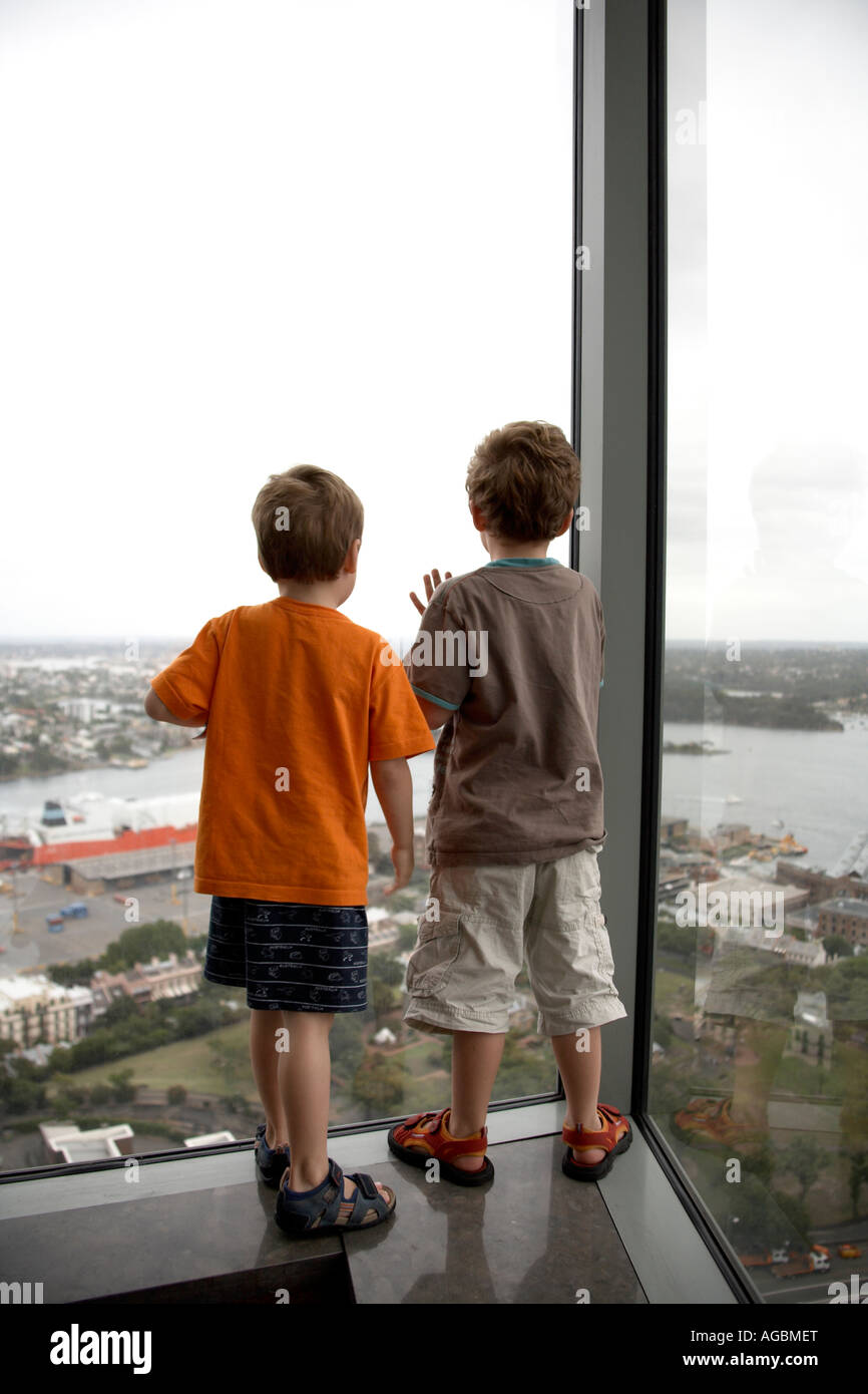 Two young boys children brothers looking at high level view from top of ...