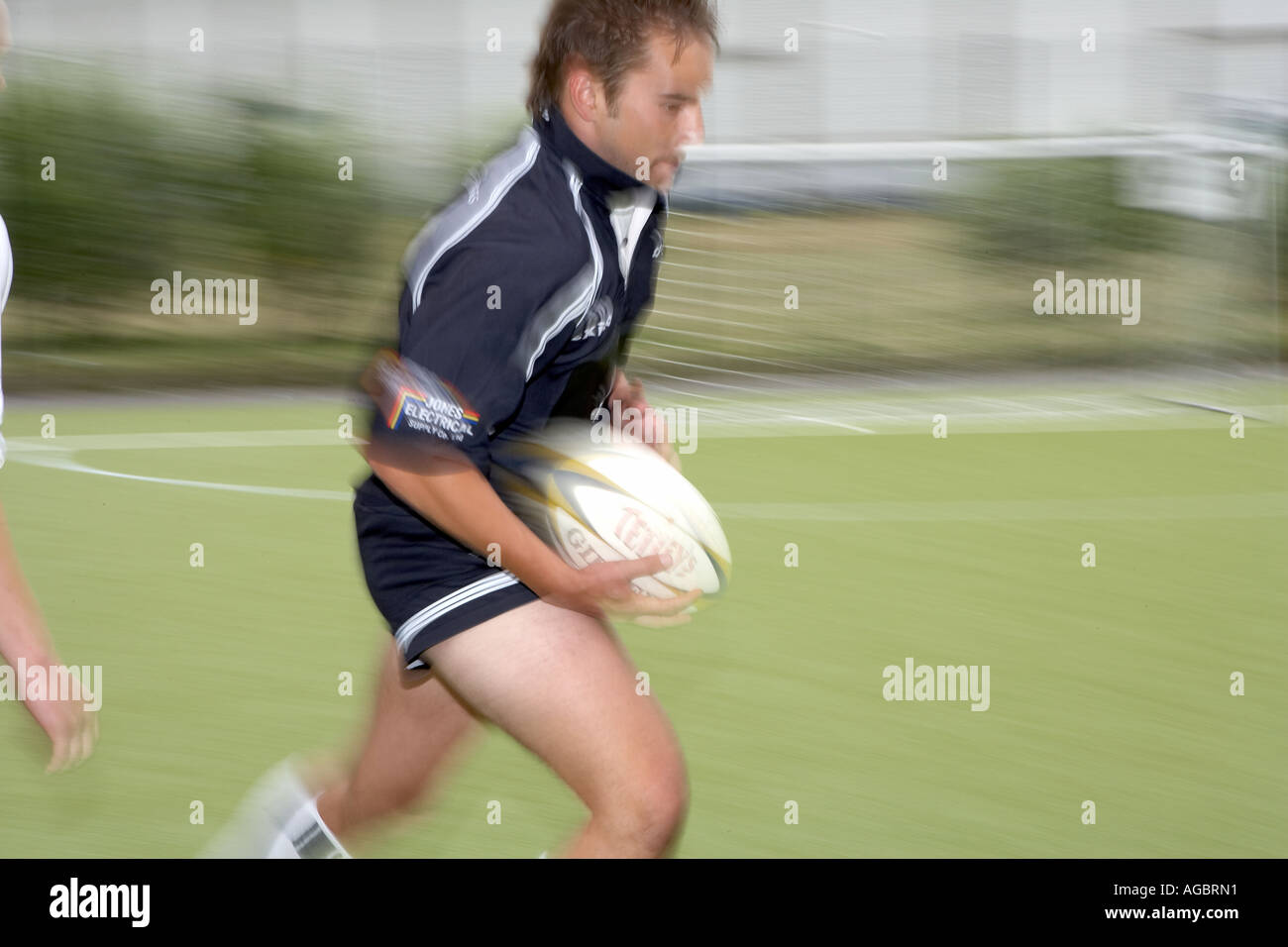Rugby players running with the ball blurred with movement Stock Photo ...