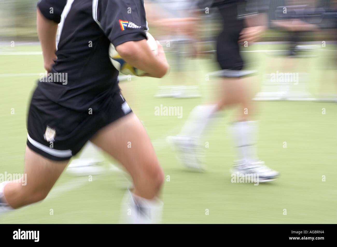 Rugby player running with the ball blurred and moving Stock Photo - Alamy