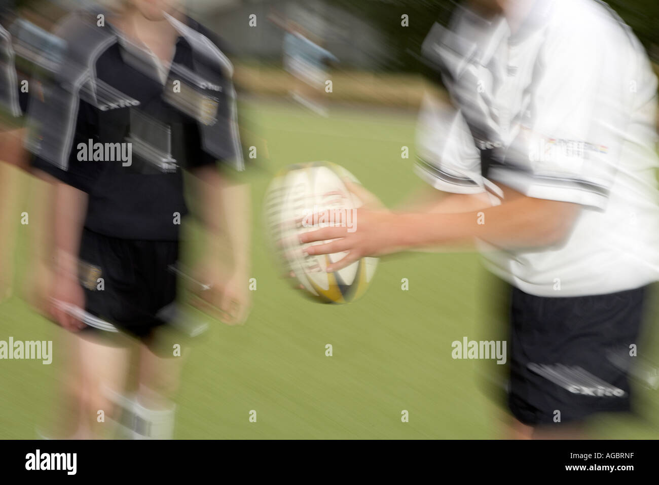 Rugby players and ball blurred and moving Stock Photo - Alamy