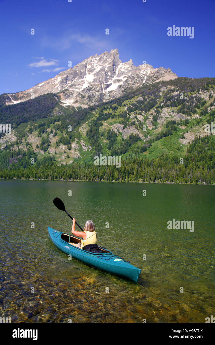 A visitor kayaking on Jenny Lake Grand Teton National Park Wyoming MR ...