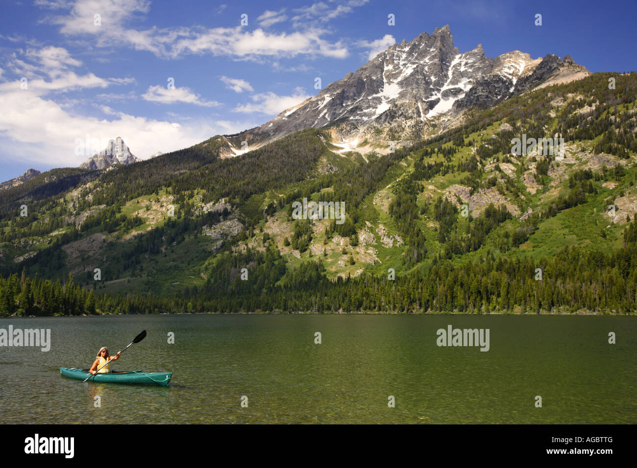 A visitor kayaking on Jenny Lake Grand Teton National Park Wyoming MR ...