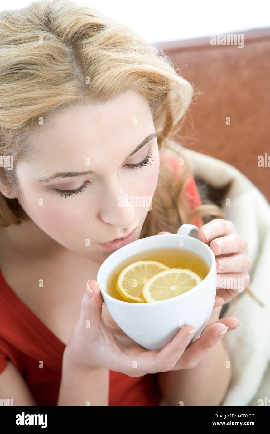 woman drinking lemon tea Stock Photo - Alamy
