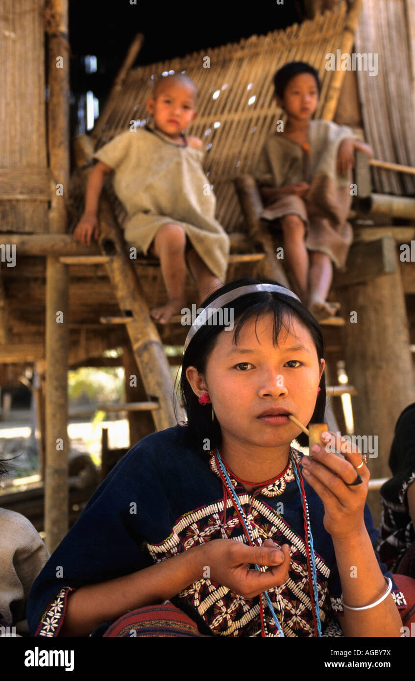 Myanmar, Bago Yoma Mountains, Woman of Karen tribe smoking bamboo pipe ...