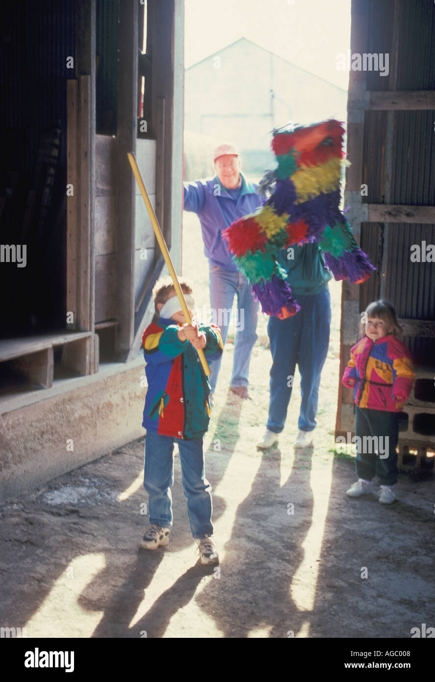Boy striking Mexican pinata Stock Photo - Alamy