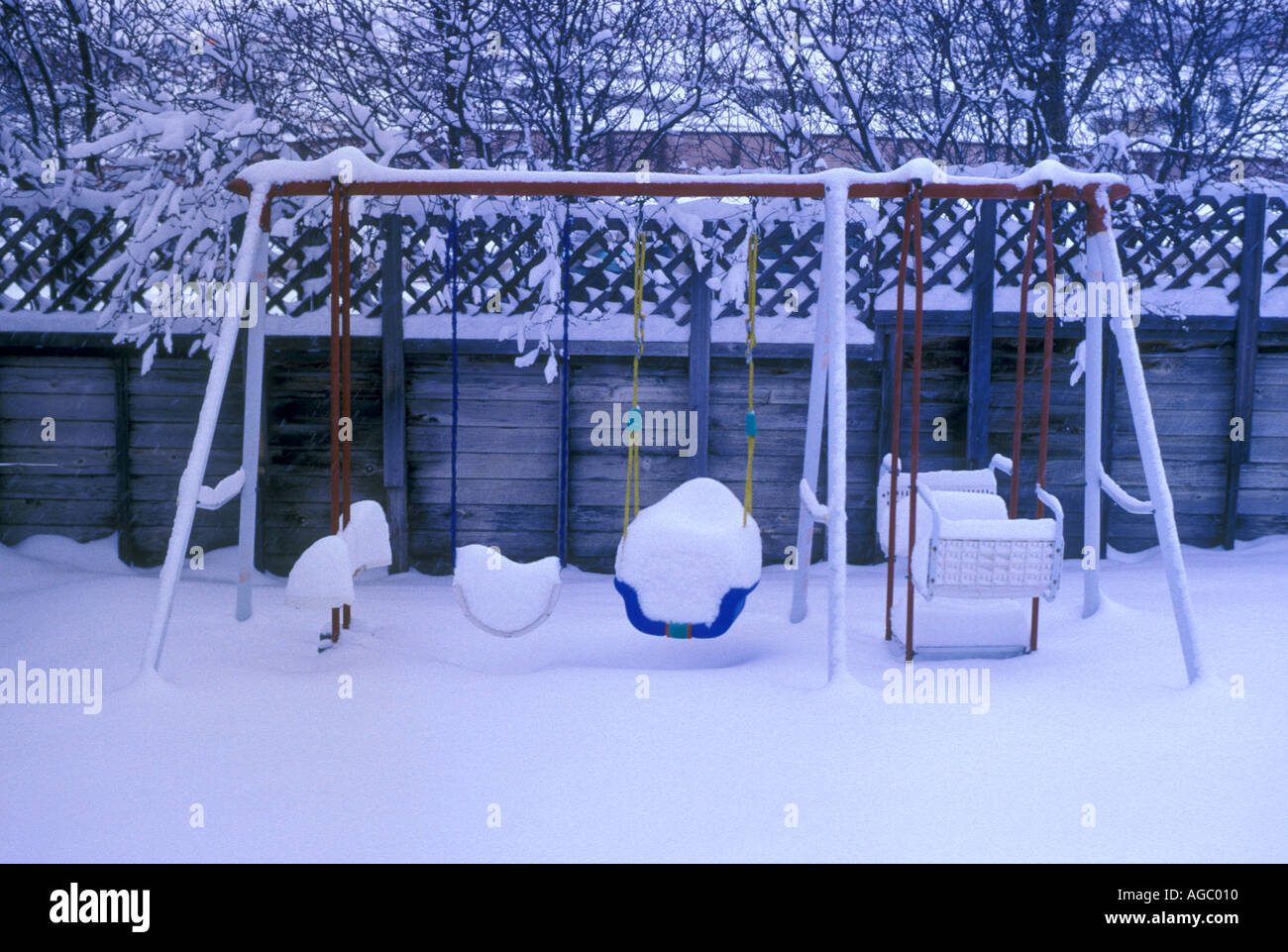 Snow fall on swing set Stock Photo - Alamy
