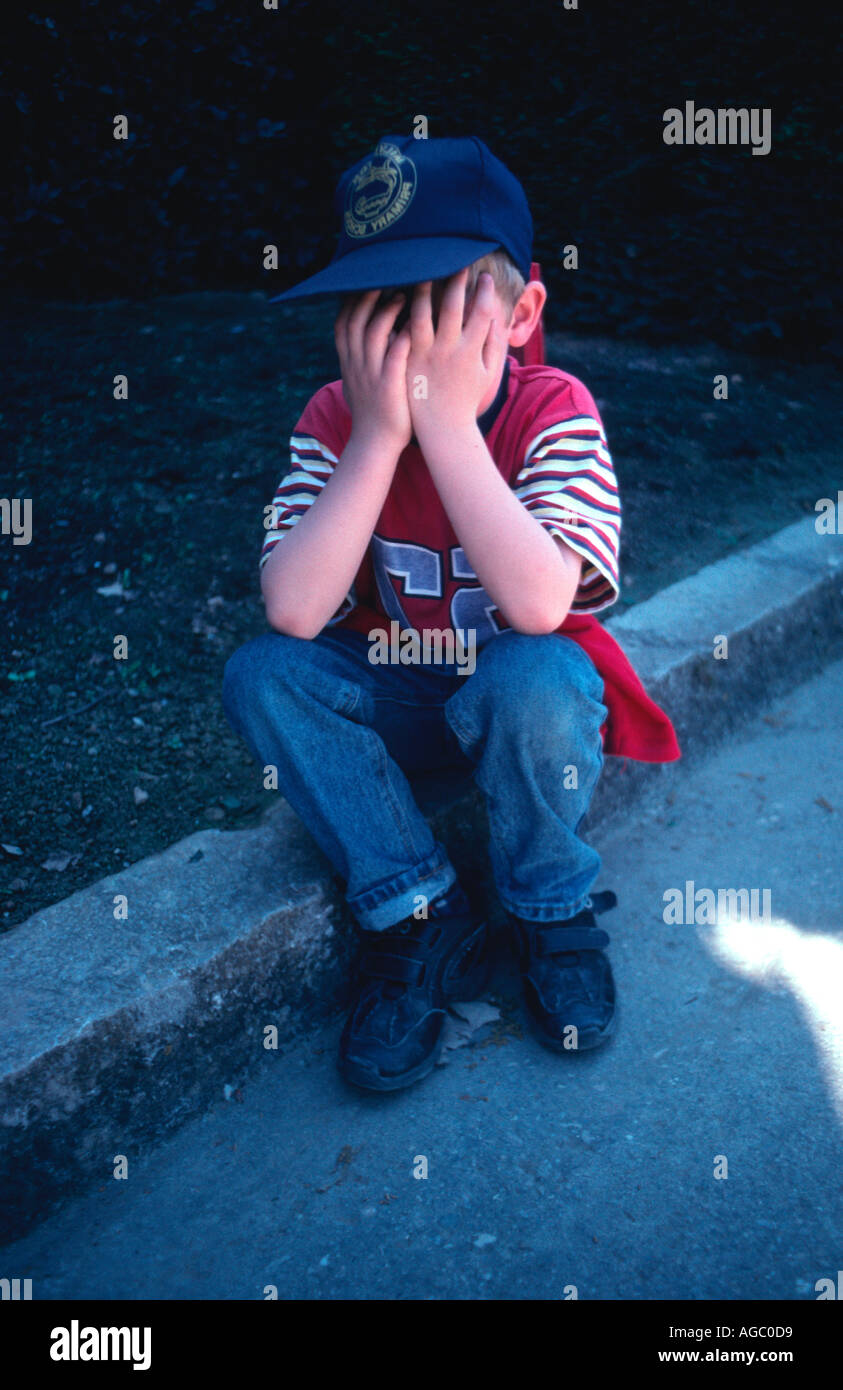 Young Boy Crying face in hands Stock Photo - Alamy