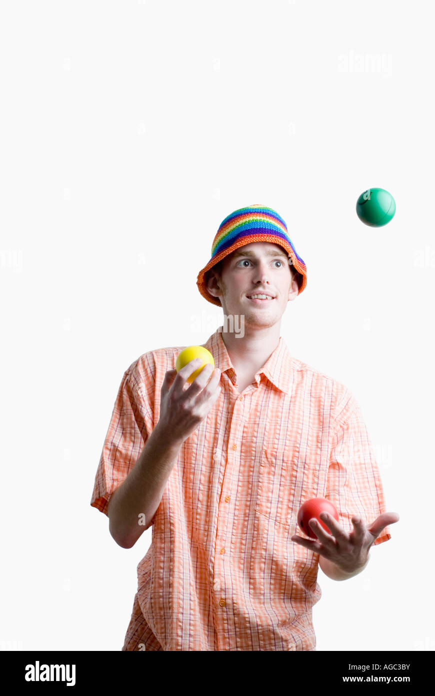 Close-up of a young man juggling balls Stock Photo - Alamy