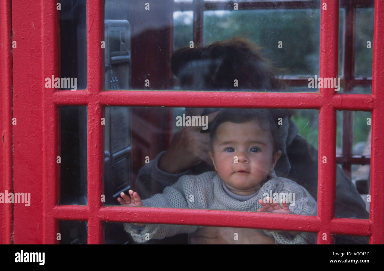 children looking through a phone box Stock Photo - Alamy