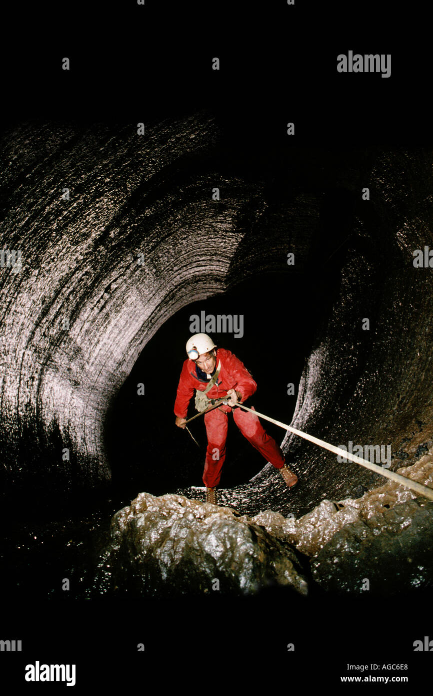 Caver descending a vertical drop in a cave in "upstate New York" USA an ...