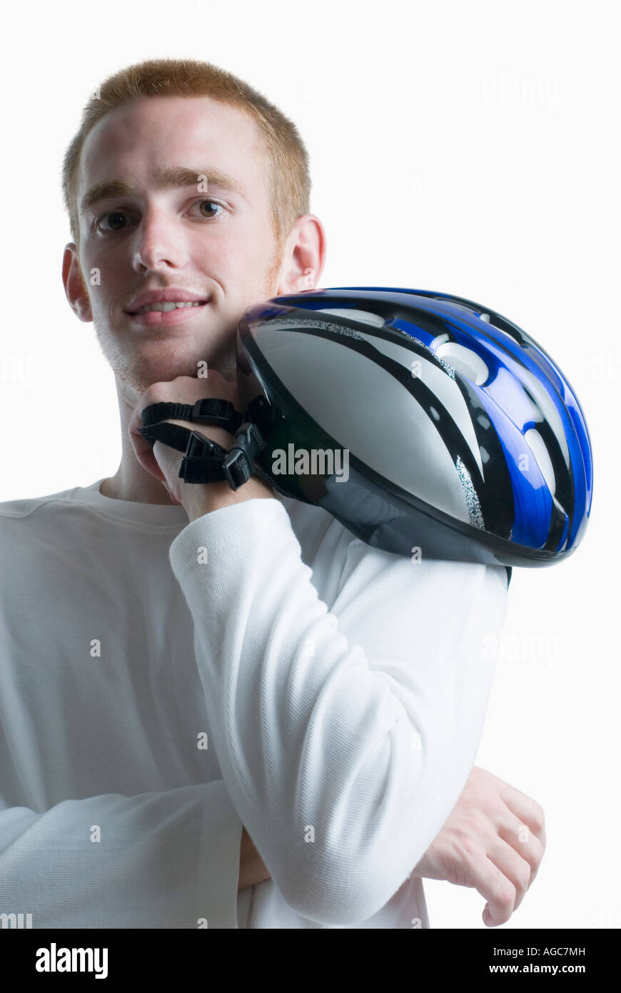 Portrait of a young man holding a sports helmet Stock Photo - Alamy
