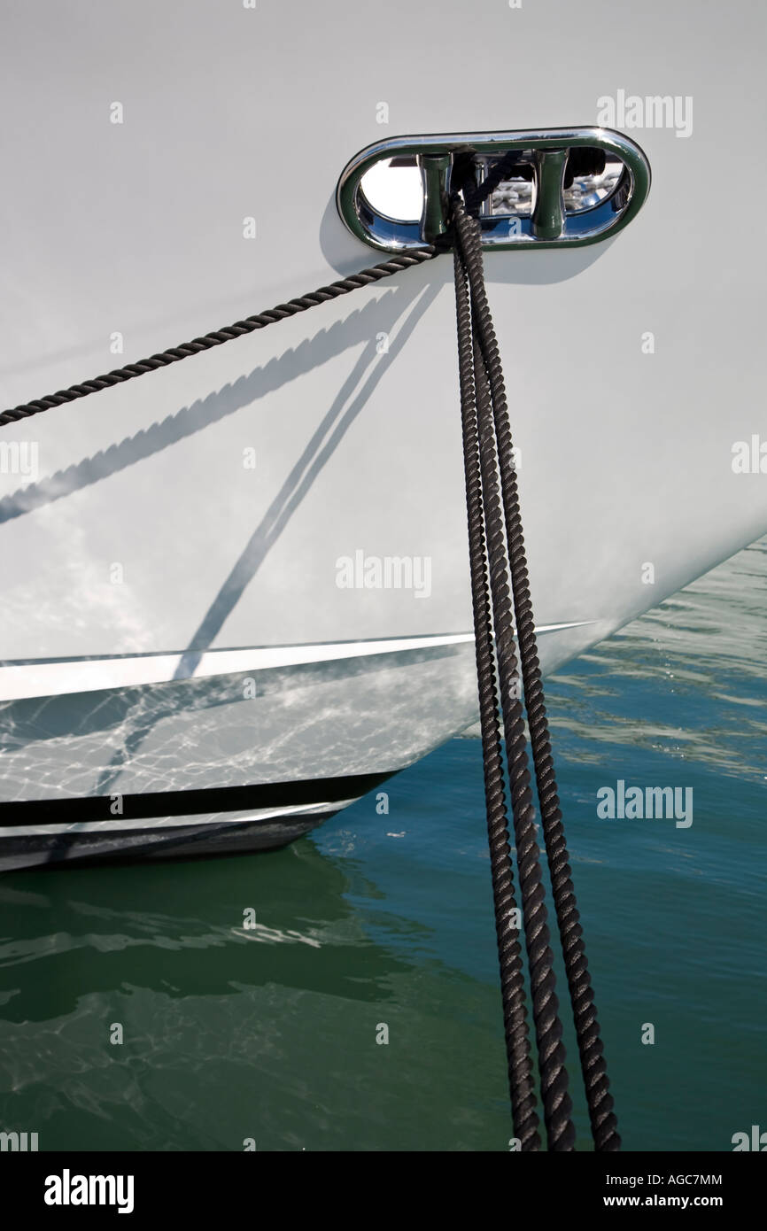 Black rope mooring lines into a stainless fairlead of an expensive ...