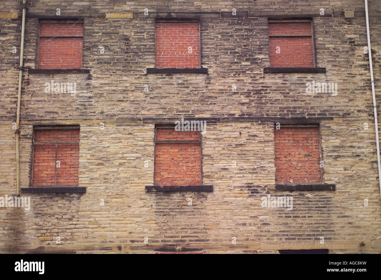 bricked up windows at an old mill / factory in the north of england ...