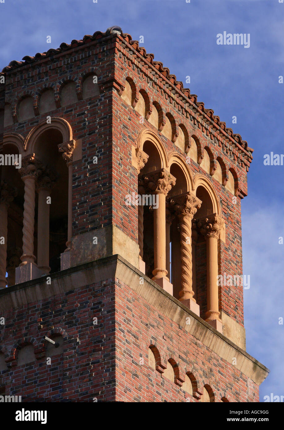 An old brick bell tower sits atop a church at a large public university ...