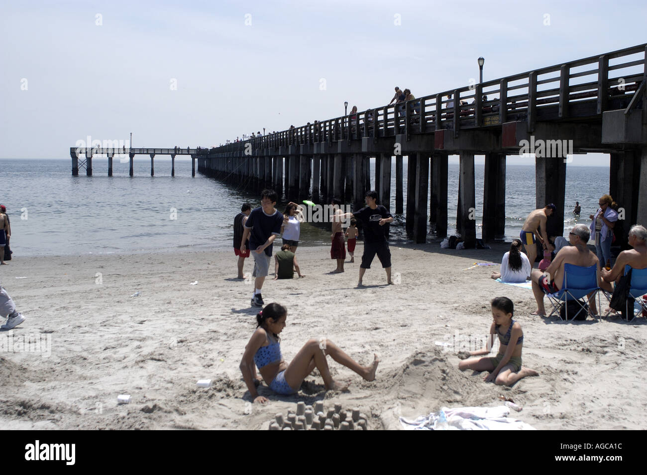 Coney Island sandy beach water pier Stock Photo - Alamy