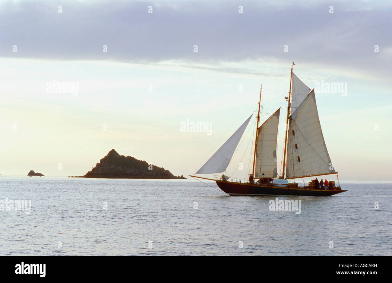 The restored 1909 British built gaff rigged schooner under sail in calm ...