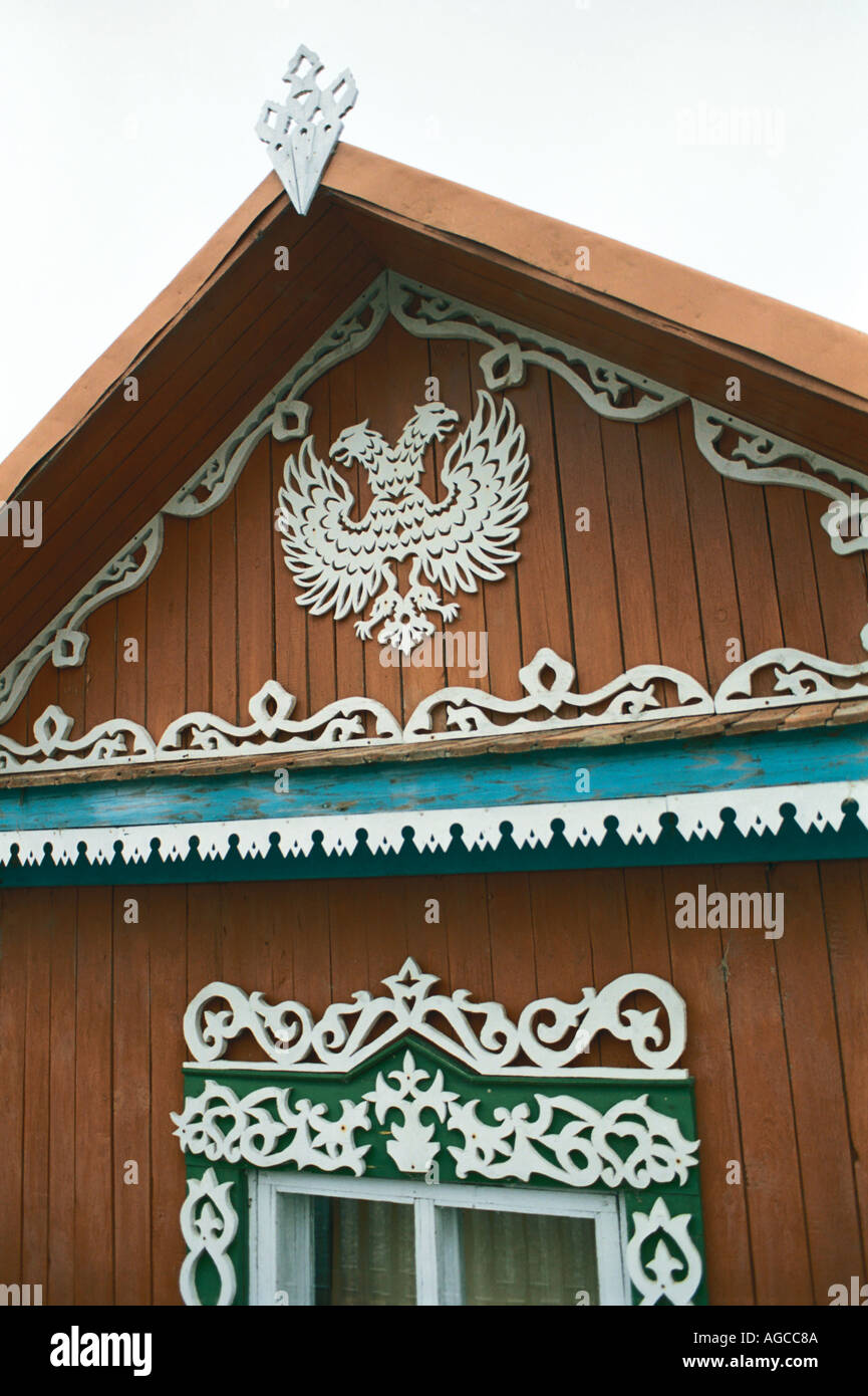 Wooden house window with native northern pattern and coat of arms of ...