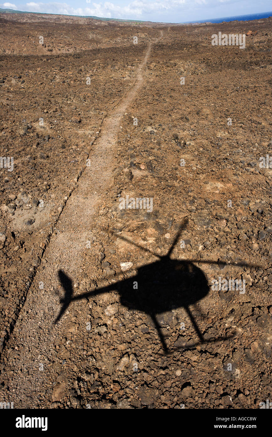 Pathway leading through rocky terrain with shadow of helicopter flying ...